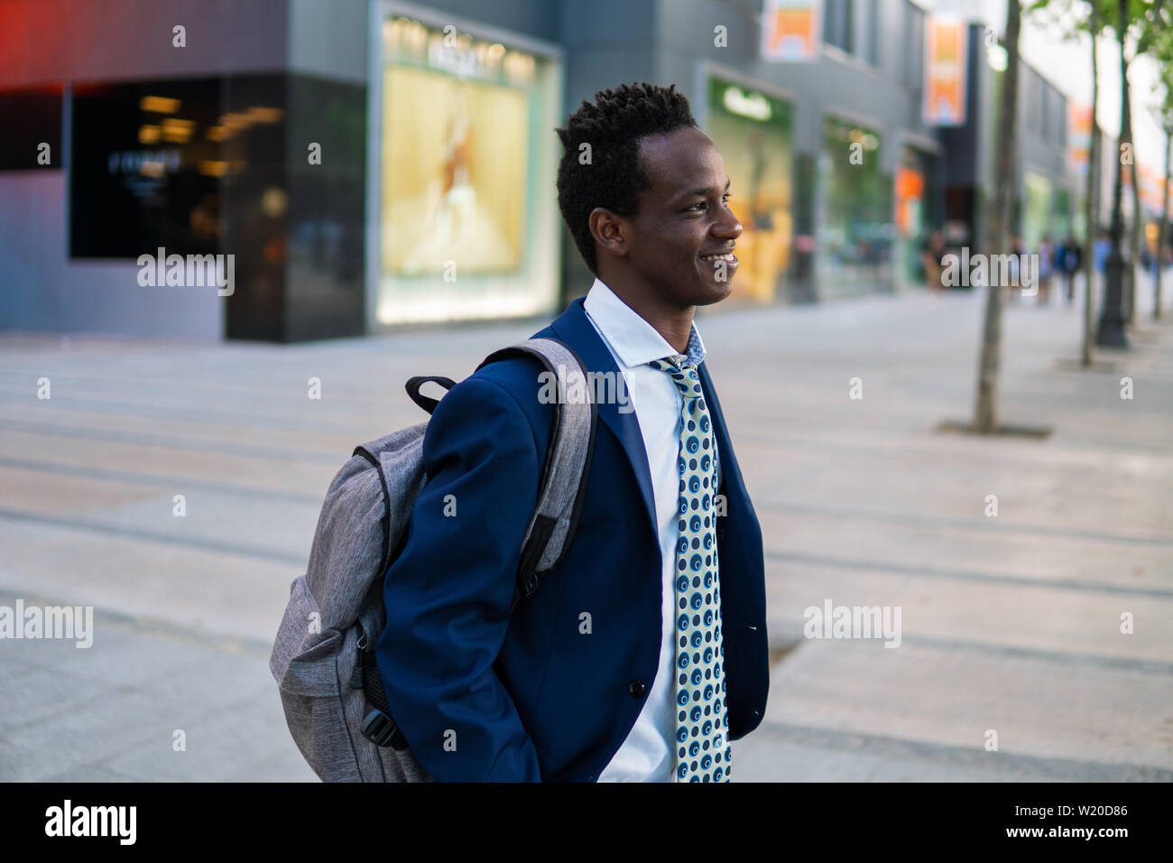 African American businessman holding laptop notebook wearing blue suit ... African American businessman holding laptop notebook wearing blue suit ...