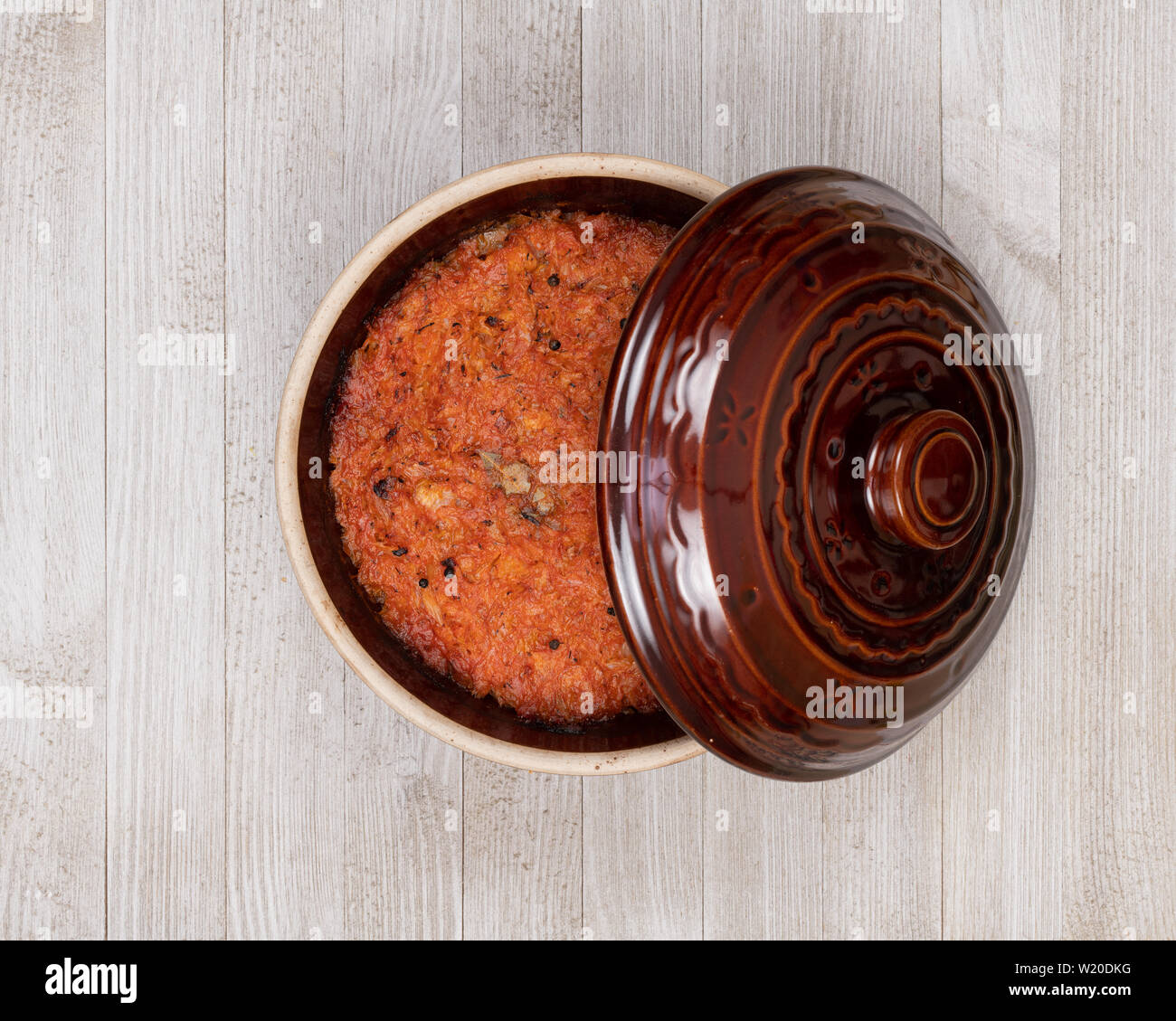 A ceramic pot of traditional Eastern European stewed cabbage on a white ...