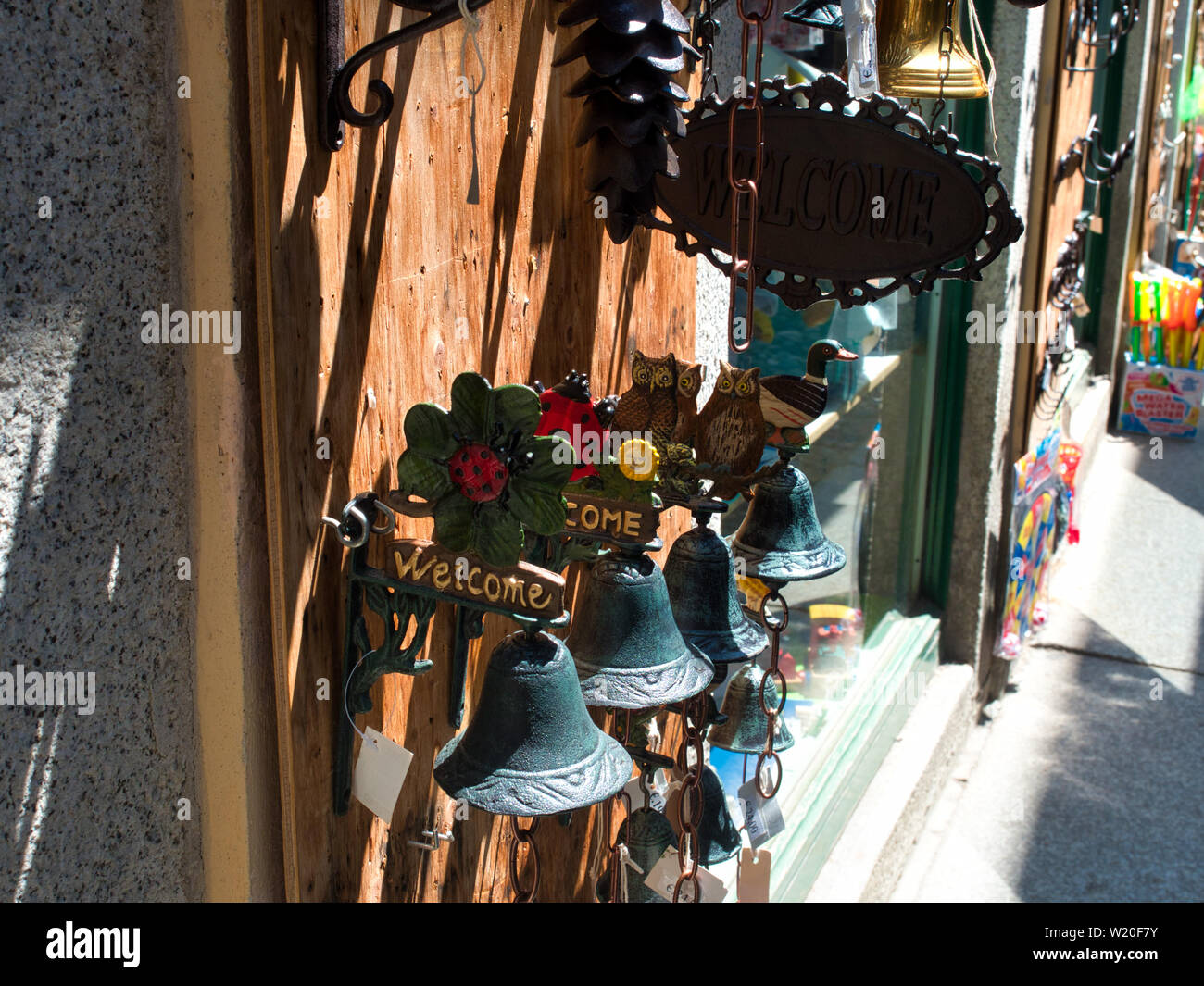 Welcome bells as souvenirs on display by a village store in Orta San ...