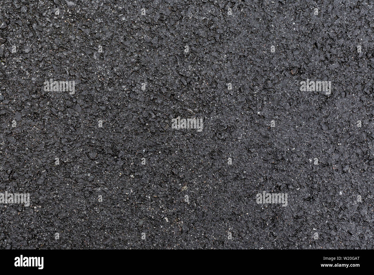 Close-up of wet, gray asphalt, viewed from above. High resolution full ...