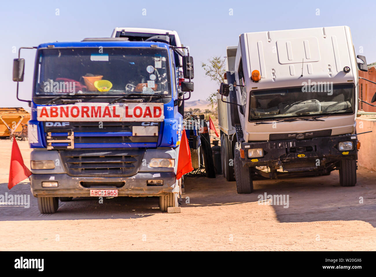 Trucks in c a car park, one with an "Abnormal Load" sign, the other ...