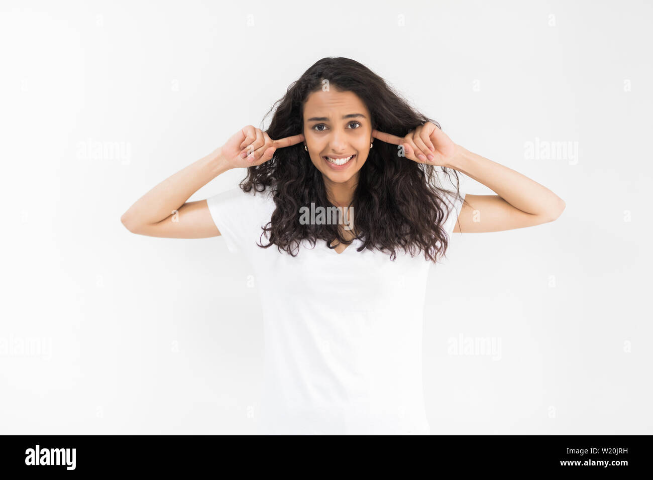 Portrait of woman close ears with hands having close eyes isolated on ...