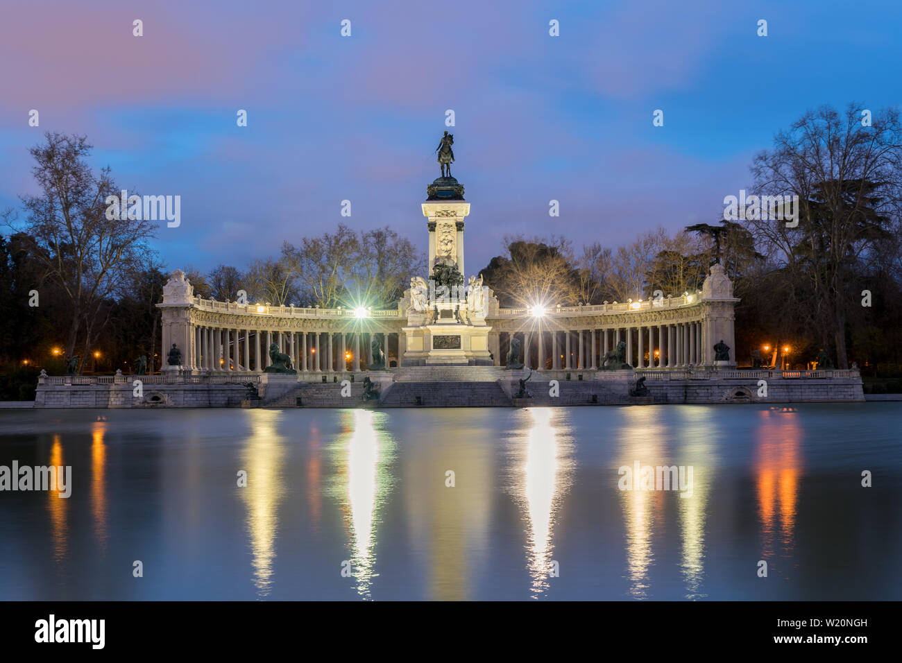 Night cityscape with lights at the memorial in Retiro city park, Madrid ...