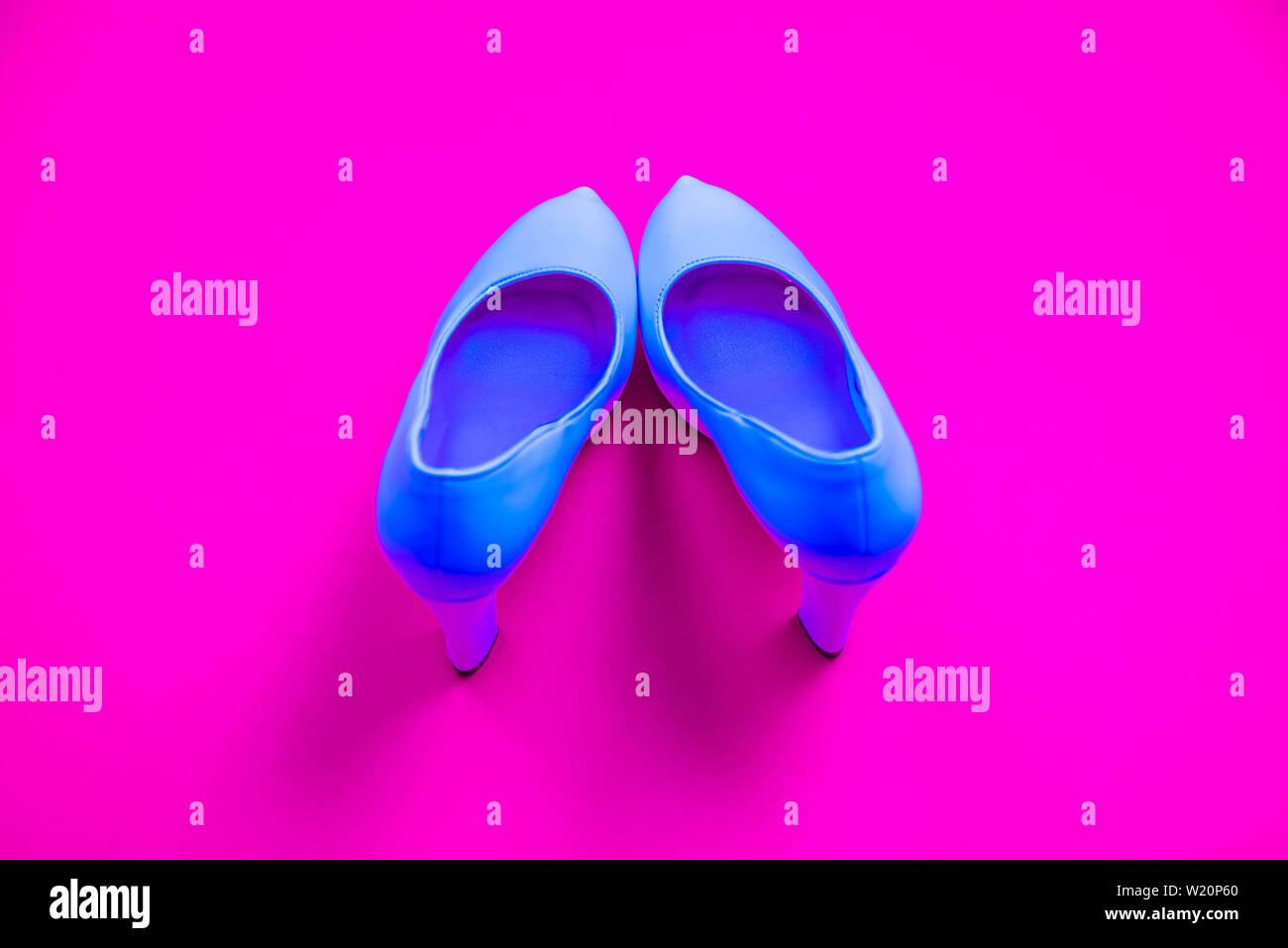 Blue high heeled shoes on pink purple background - top view concept ...