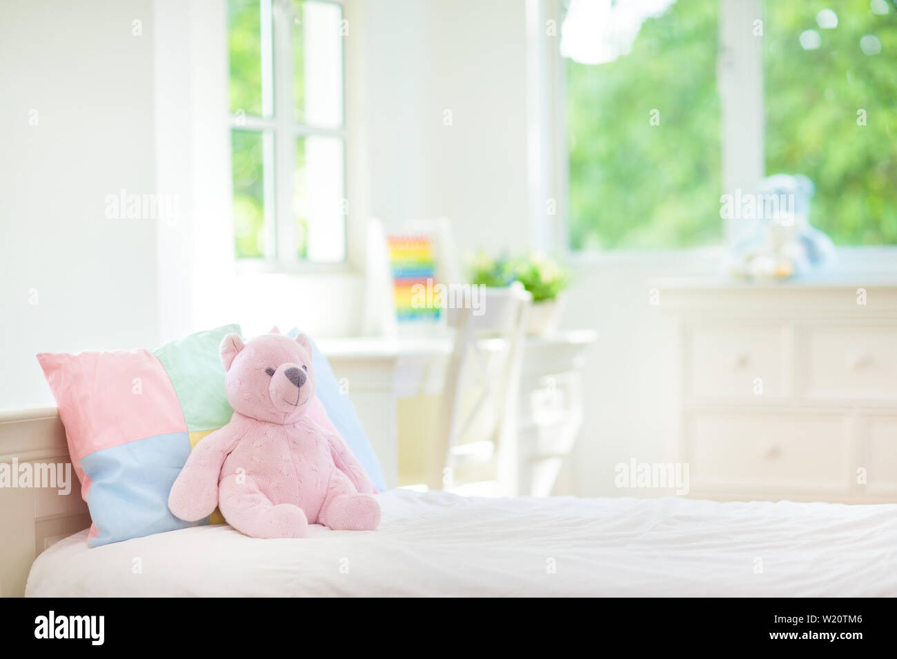 Kids bed in white sunny bedroom with window. Children room and interior ...