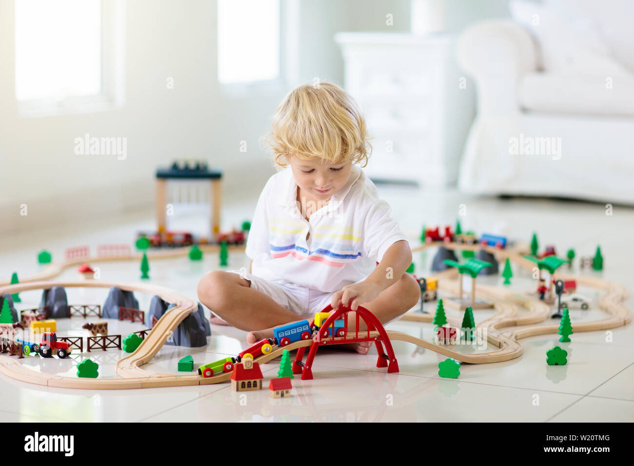 Kids play with wooden railway. Child with toy train. Educational toys ...