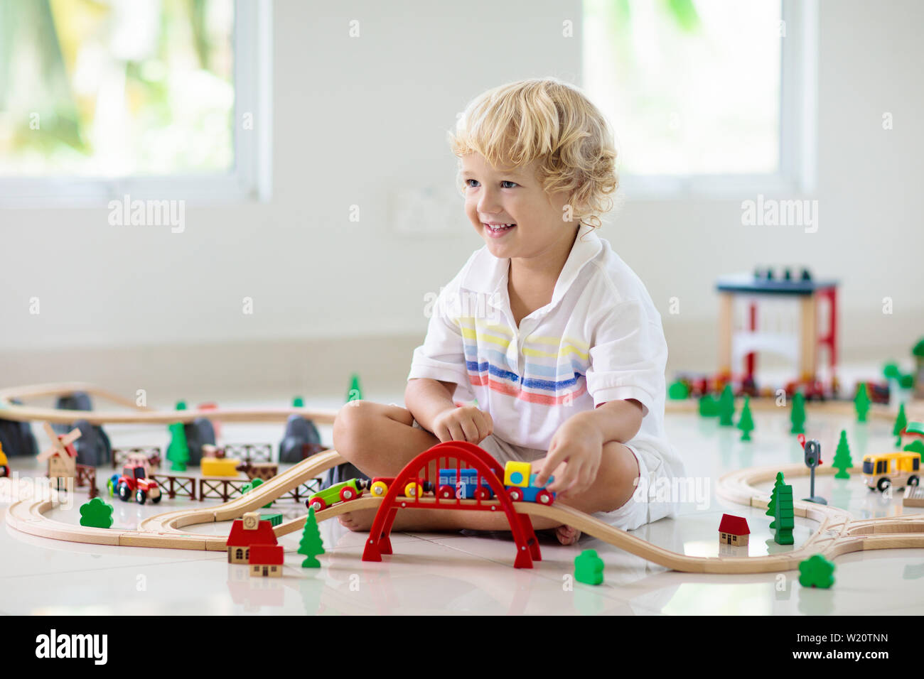 Kids play with wooden railway. Child with toy train. Educational toys ...