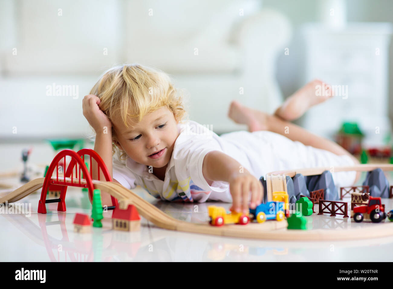 Kids play with wooden railway. Child with toy train. Educational toys ...