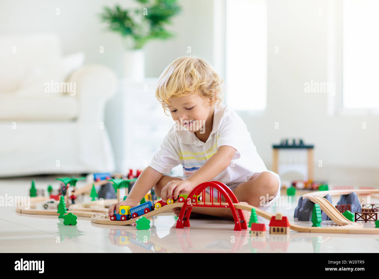 Kids play with wooden railway. Child with toy train. Educational toys ...
