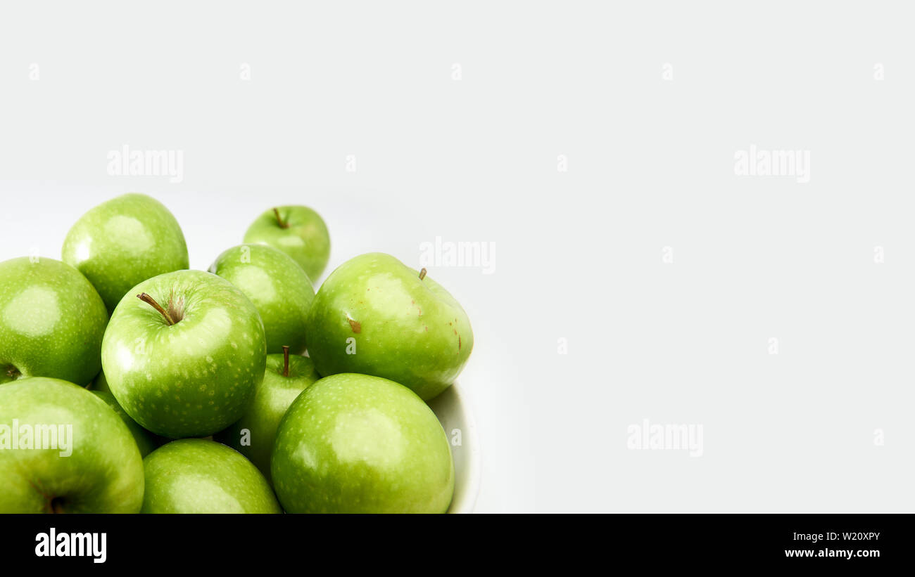 Green Granny Smith cooking apples in a white bowl from above against a ...