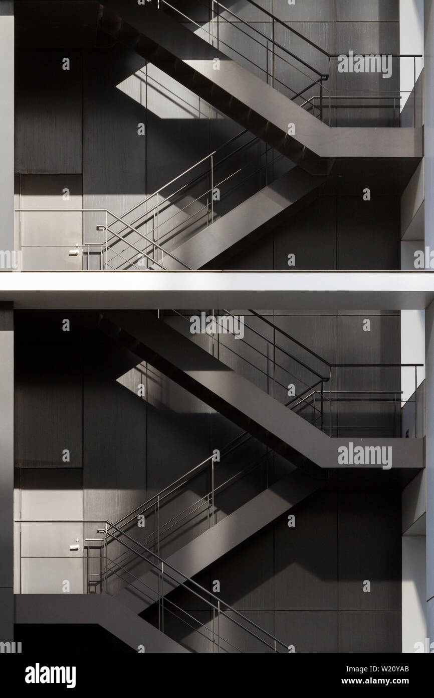 Metal staircases on the outside of a tall building in Tokyo, Japan ...