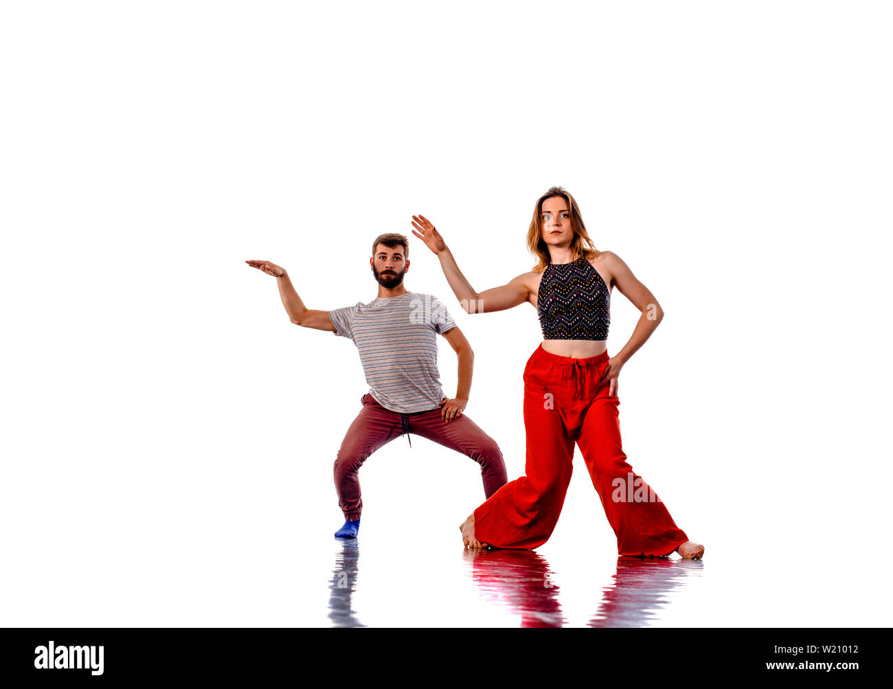 Romantic couple dancing together in studio, isolated on white ...