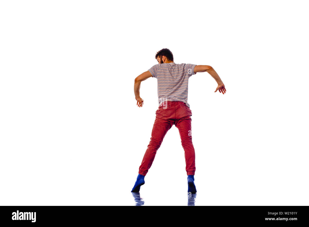 Happy young man dancing against plain white background Stock Photo - Alamy