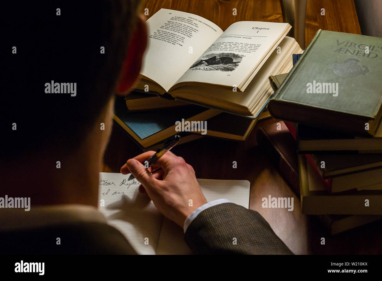 Looking over the shoulder of a man writing a letter Stock Photo - Alamy