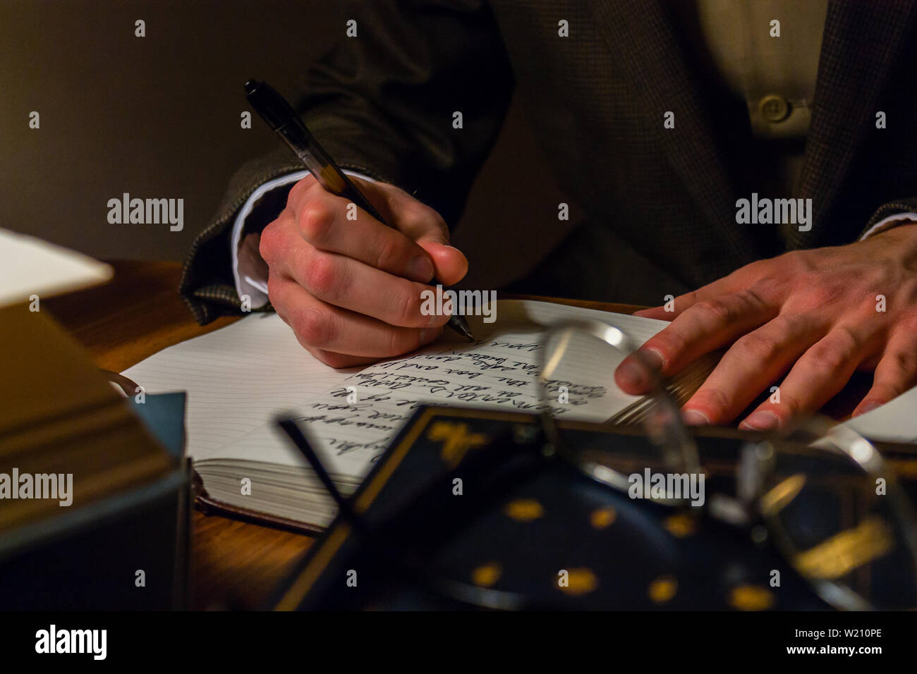 Writing a letter late in the night after reading books Stock Photo - Alamy