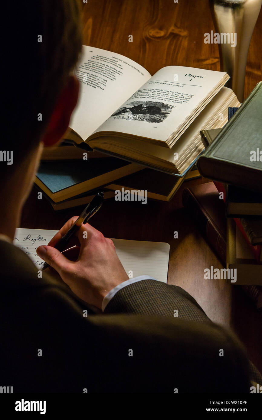 Writing a letter while reading works of literature Stock Photo - Alamy