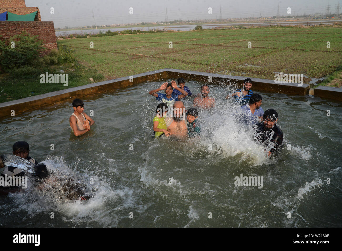 Lahore, Pakistan. 01st July, 2019. Pakistani youths cool off from local ...
