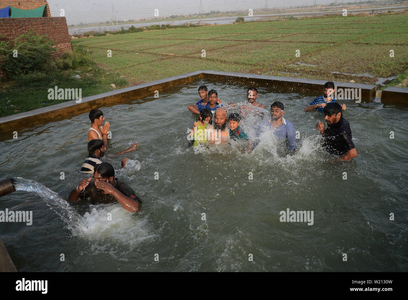 Lahore, Pakistan. 01st July, 2019. Pakistani youths cool off from local ...