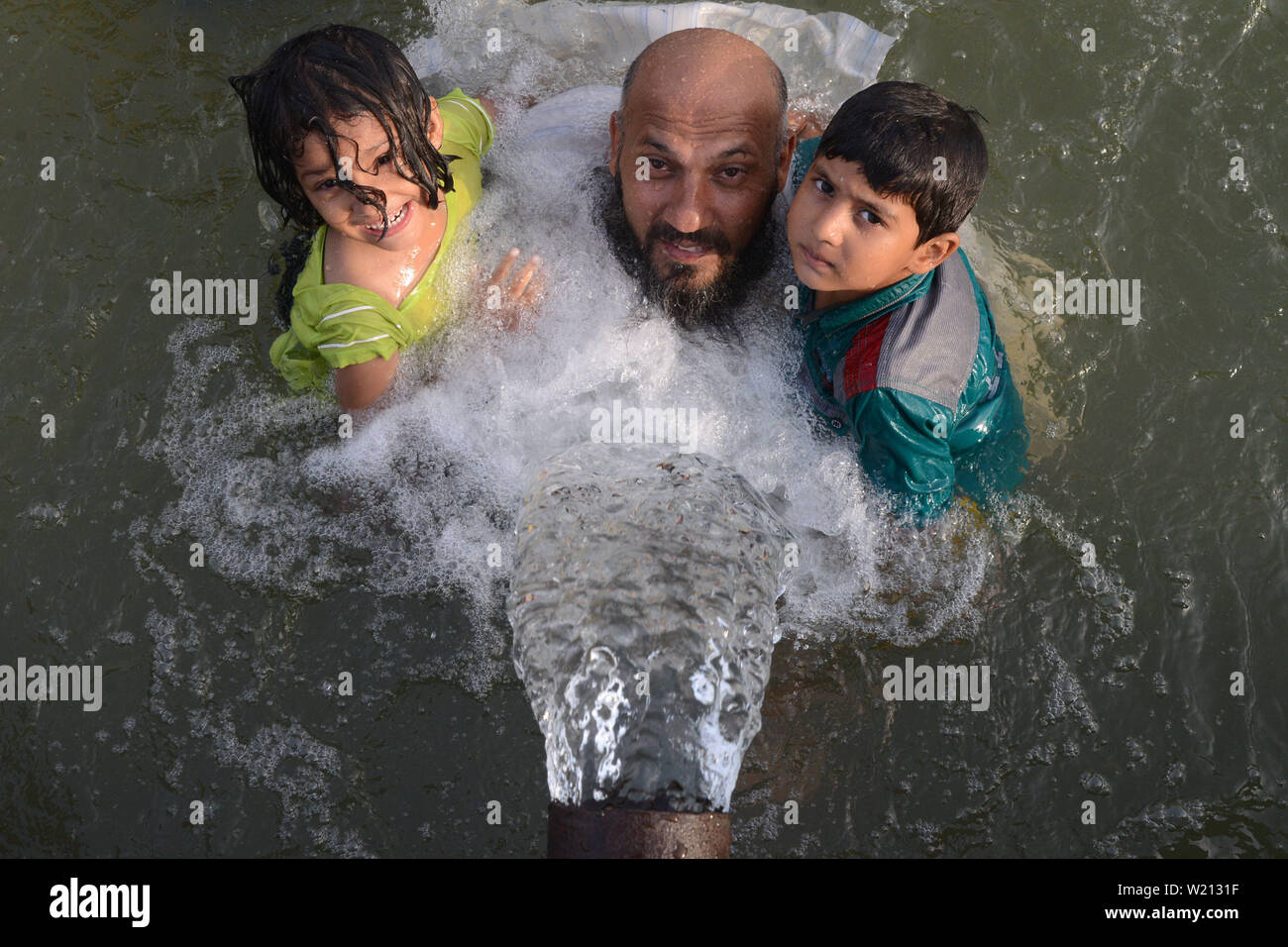 Lahore, Pakistan. 01st July, 2019. Pakistani youths cool off from local ...