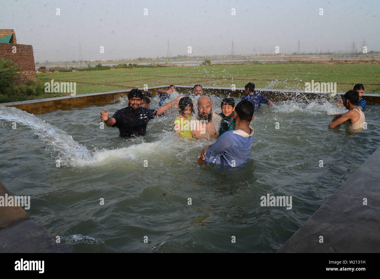 Lahore, Pakistan. 01st July, 2019. Pakistani youths cool off from local ...