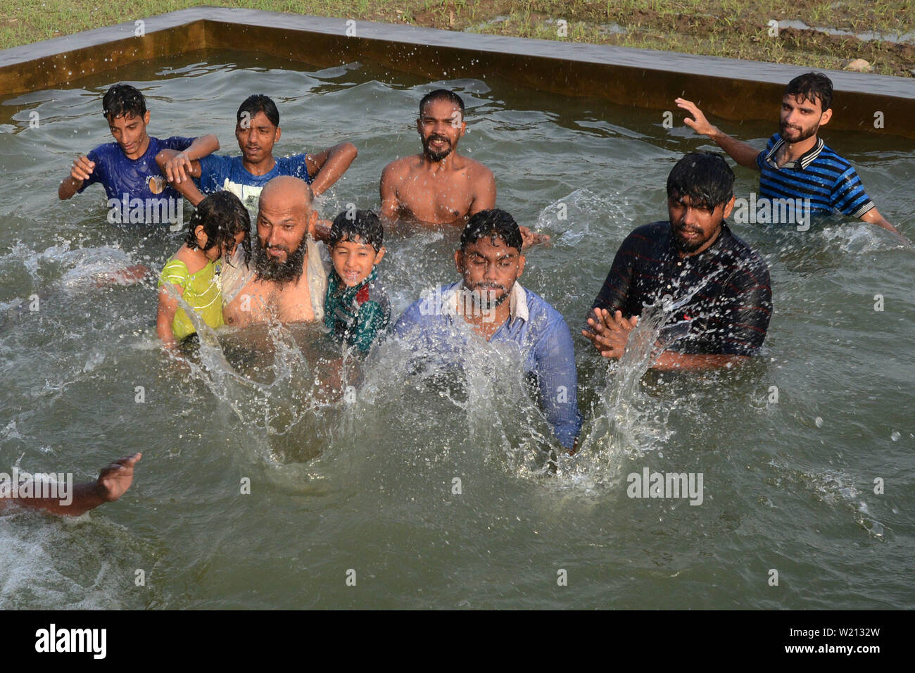 Lahore, Pakistan. 01st July, 2019. Pakistani youths cool off from local ...