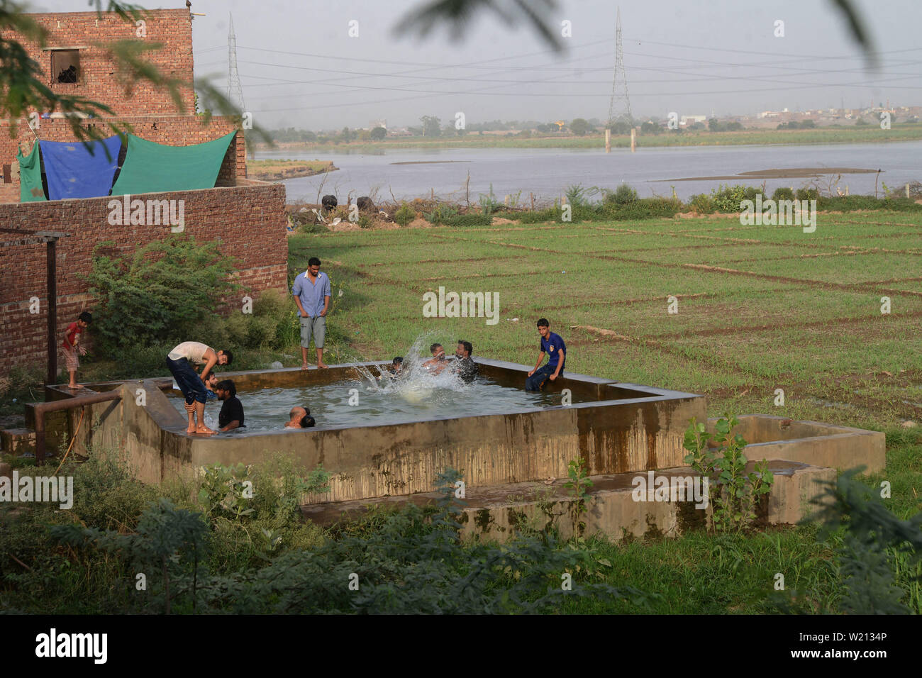 Lahore, Pakistan. 01st July, 2019. Pakistani youths cool off from local ...