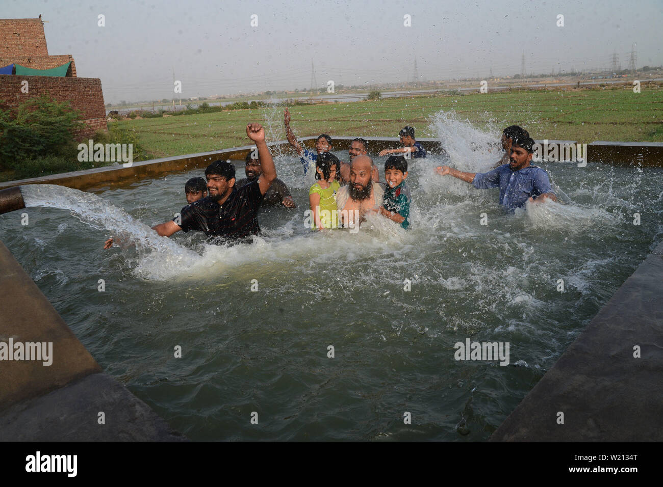 Lahore, Pakistan. 01st July, 2019. Pakistani youths cool off from local ...