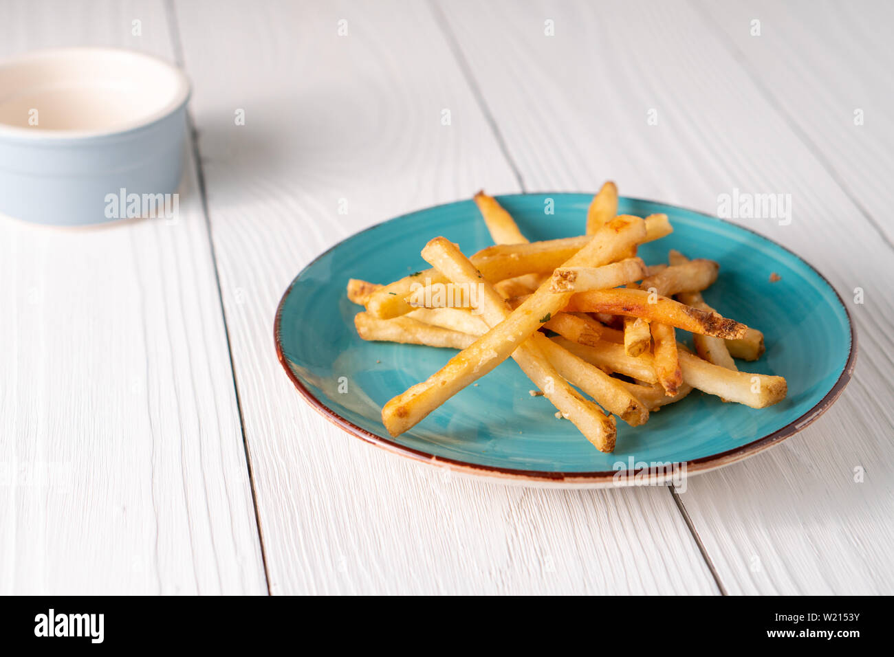 Fresh hot crispy French fries on farmhouse table Stock Photo - Alamy