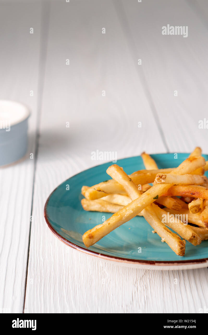 Fresh hot crispy French fries on farmhouse table Stock Photo - Alamy