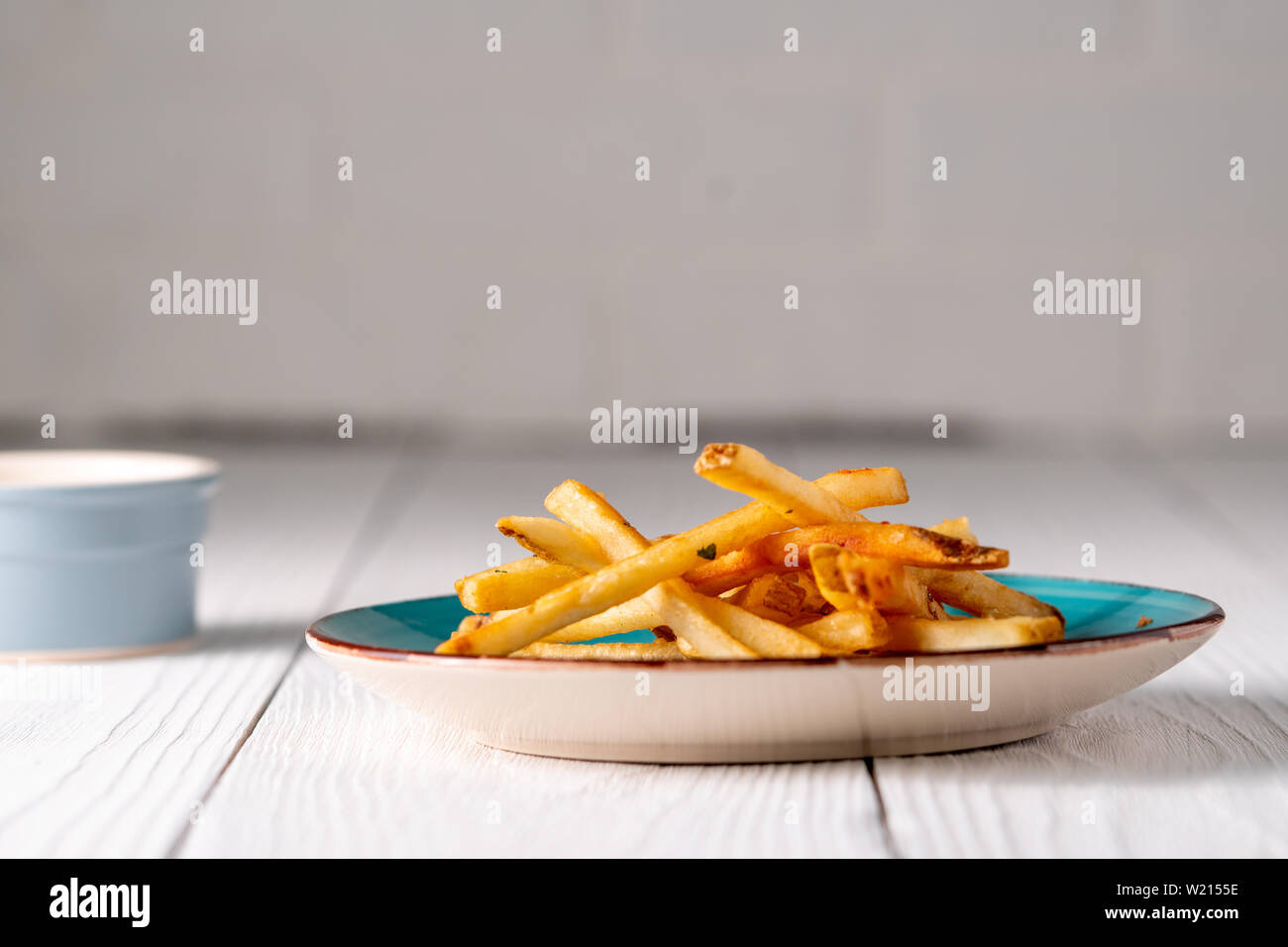 Fresh hot crispy French fries on farmhouse table Stock Photo - Alamy