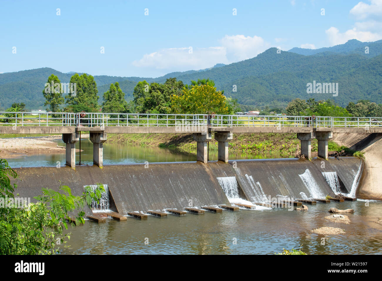 Concrete bridge over the weir in the river. Which flows from the ...