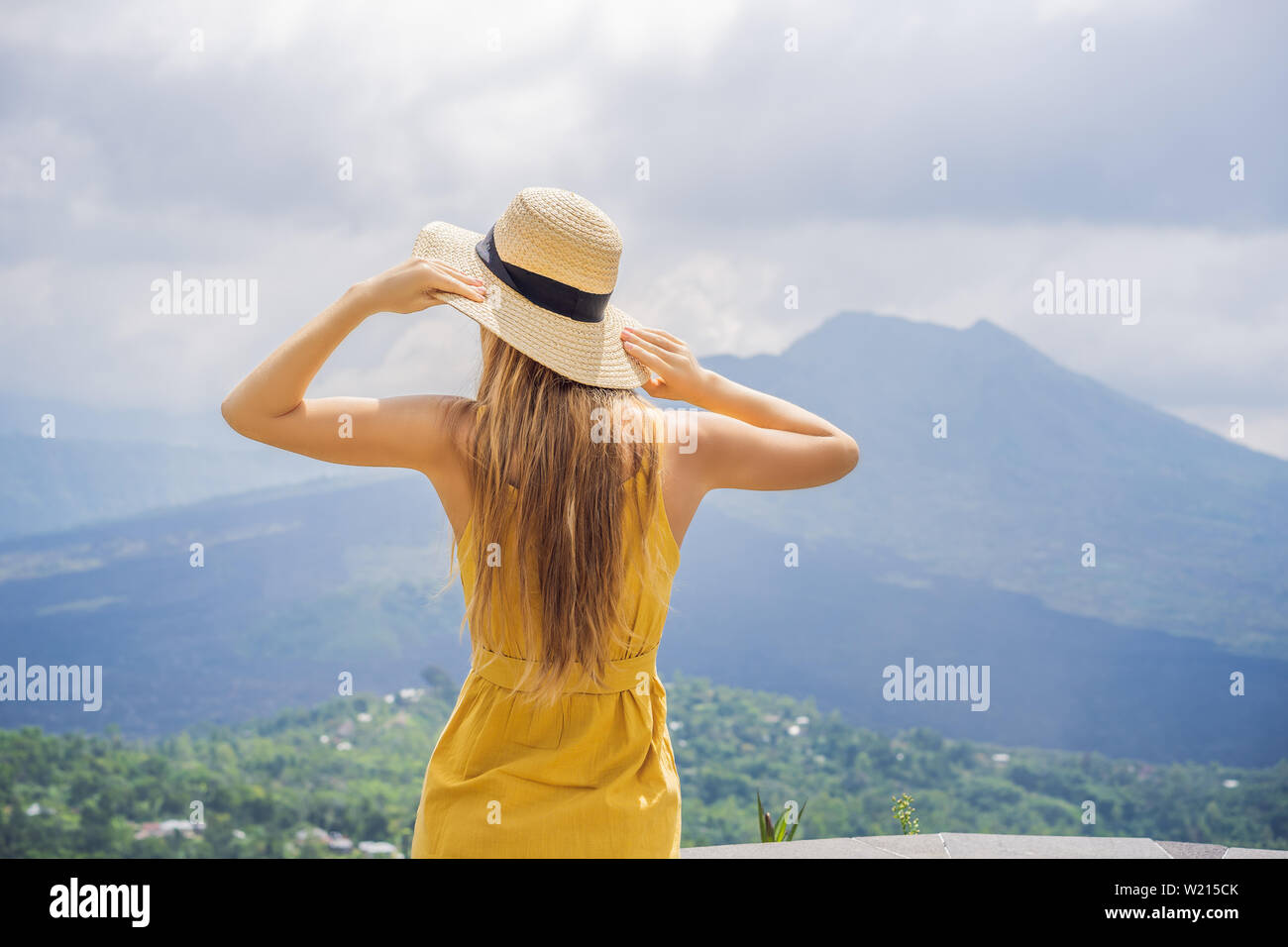 Woman traveler looking at batur volcano hi-res stock photography and ...