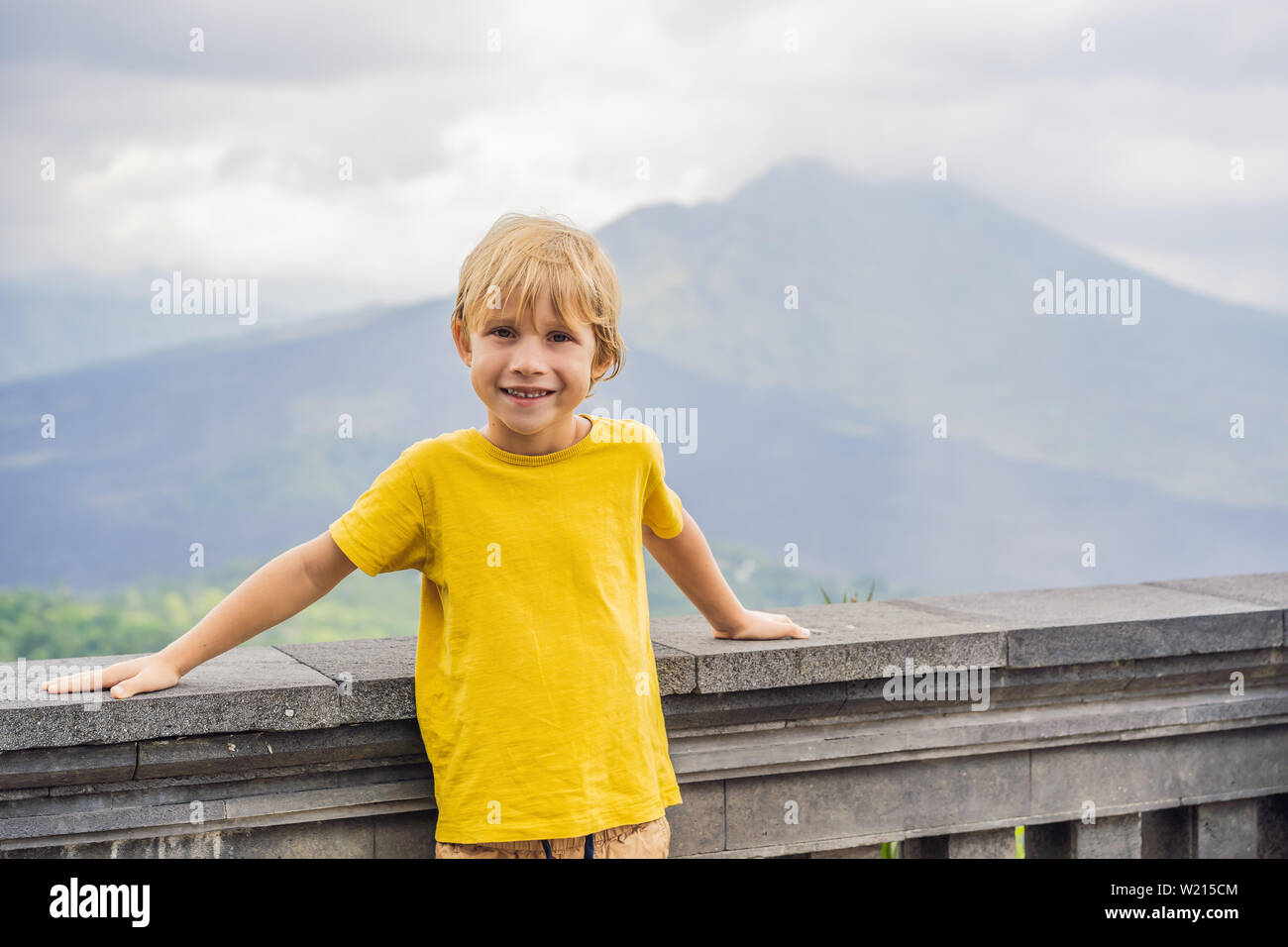 Boy tourist on background looking at Batur volcano. Indonesia ...