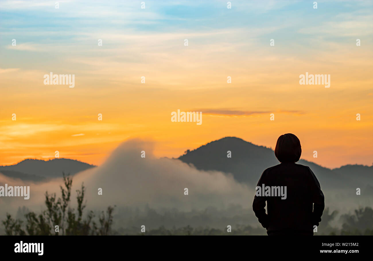 Blurry morning sun light behind the mountains with the shadow of a ...