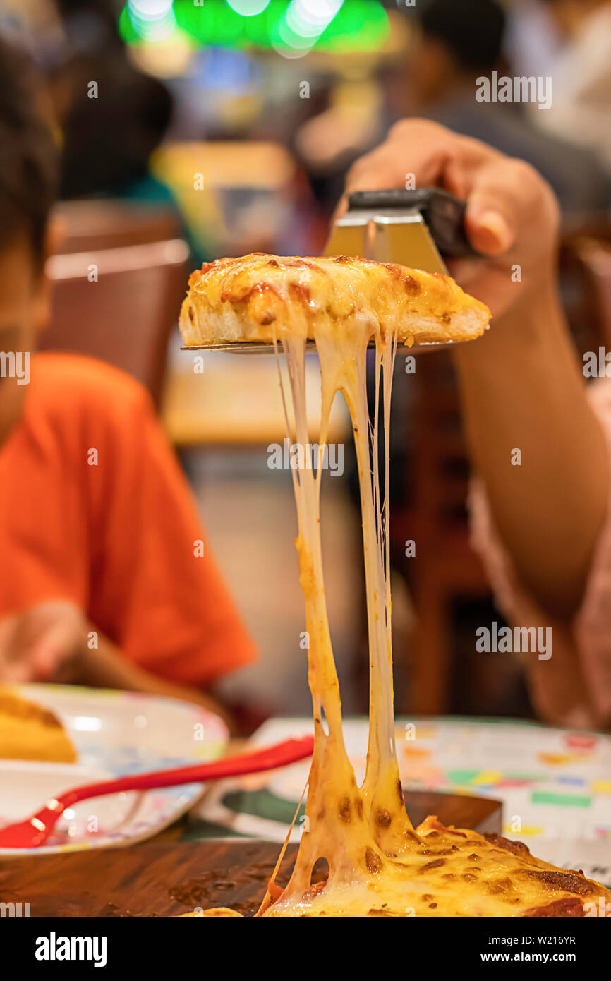 Hand holding pizza hi-res stock photography and images - Alamy