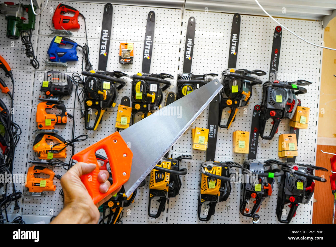 Chelyabinsk Region, Russia - JUNE 2019. Hand saw in hand against the ...