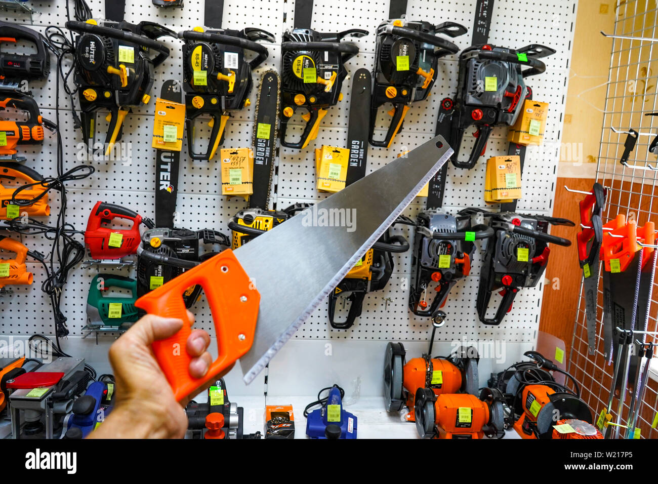 Chelyabinsk Region, Russia - JUNE 2019. Hand saw in hand against the ...