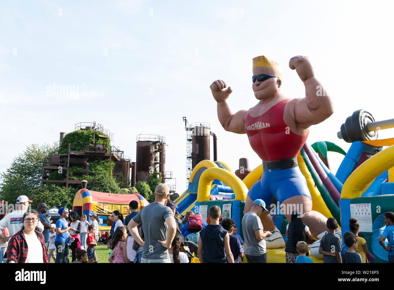 A giant inflatable ironman figure stands over visitors at the Seafair ...