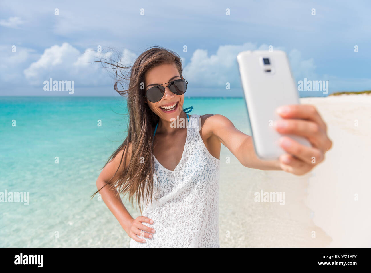 Cheerful Young Woman Having Fun Taking Smartphone Selfie Pictures Of