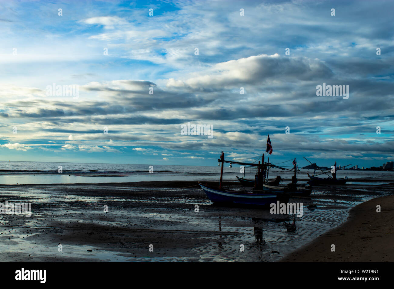 The morning sun light in the sea, and the boat on the beach Stock Photo ...