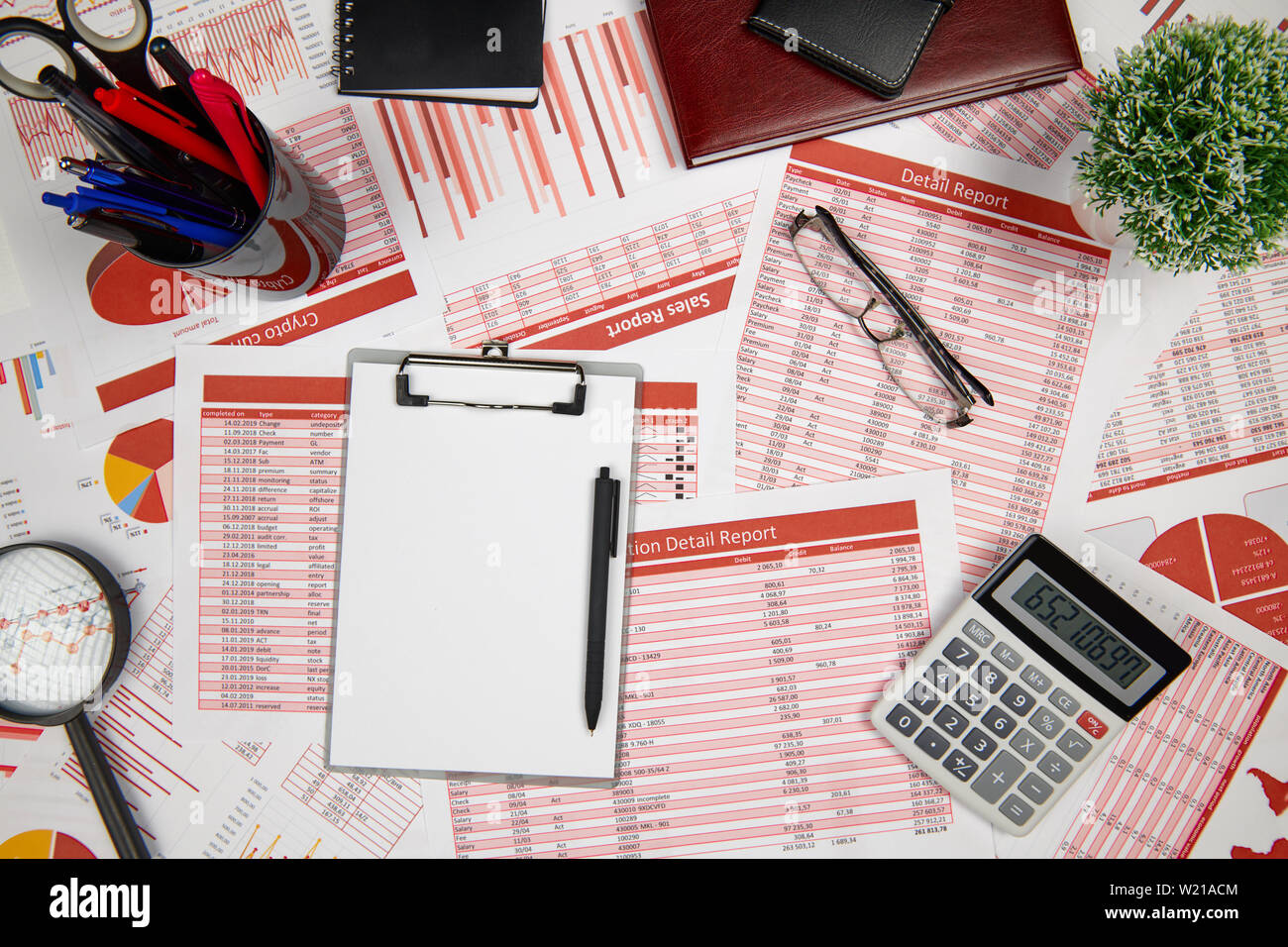 Business reports, blank paper sheet, data tables and charts - directly ...
