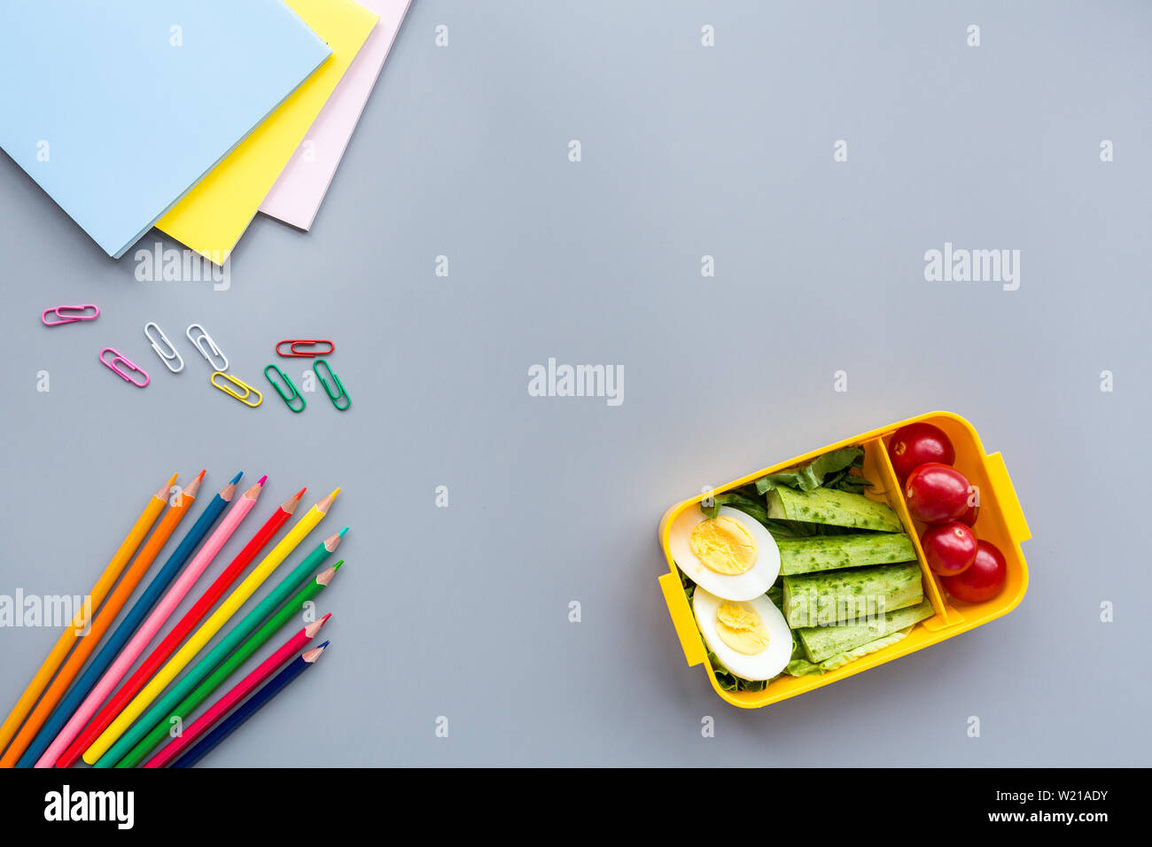 School supplies and lunch box with sandwich and vegetables. Back to ...