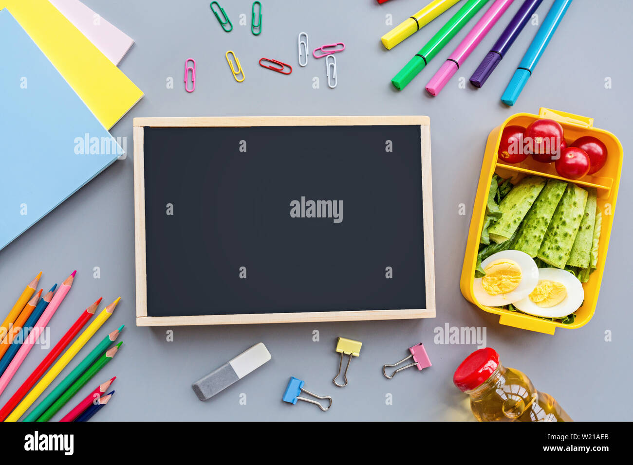 School supplies and lunch box with sandwich and vegetables. Back to ...