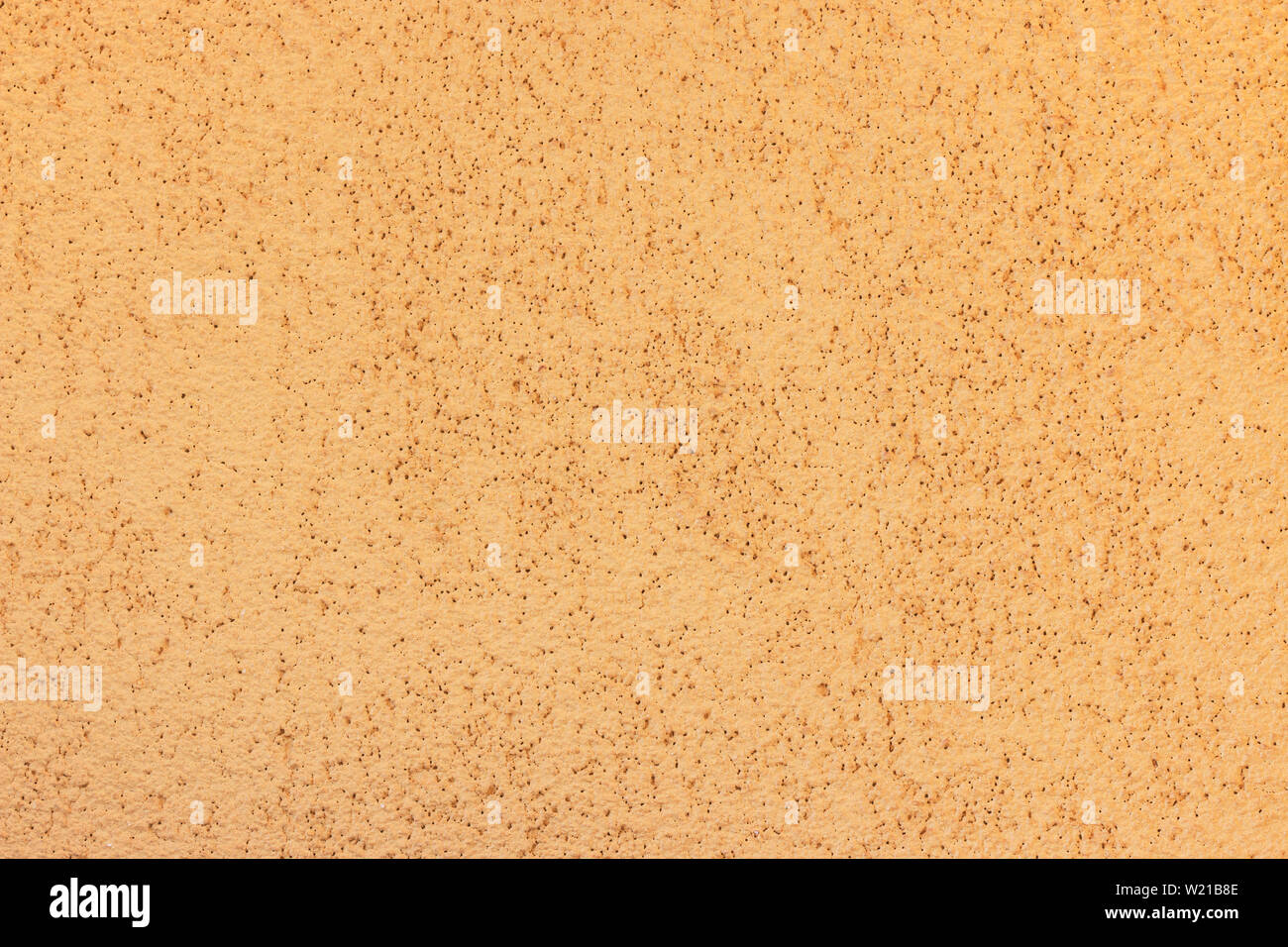 Texture of orange color concrete wall with small holes Stock Photo - Alamy