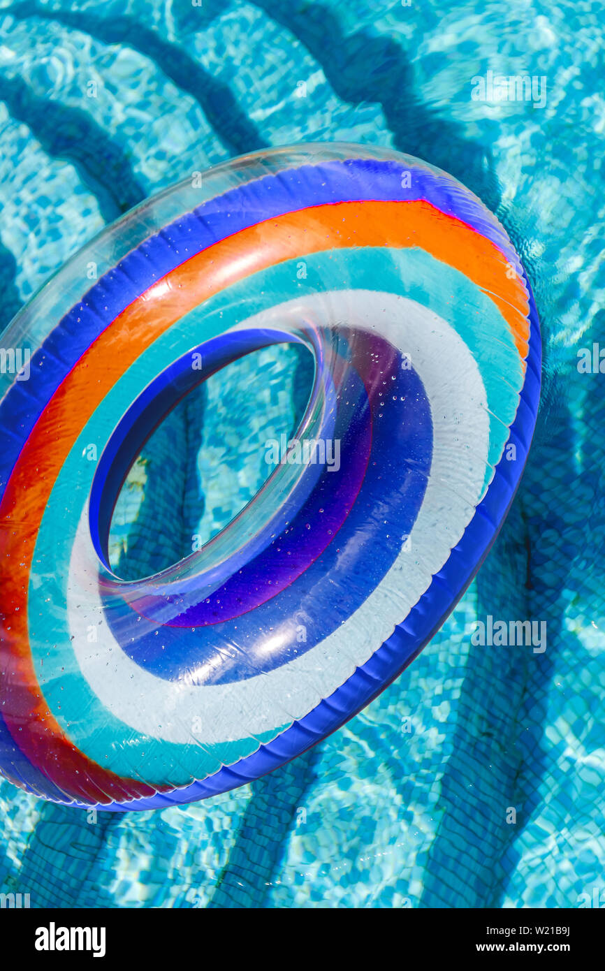 Inflatable water activities circles tuba float on the water in the pool ...