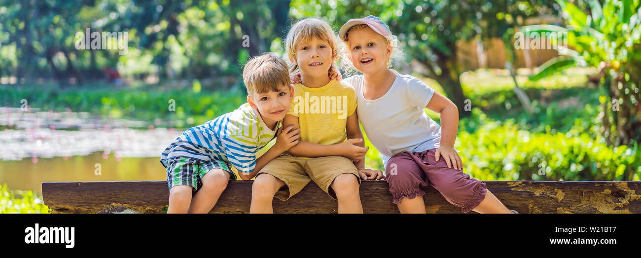 Children rest during a hike in the woods BANNER, LONG FORMAT Stock ...