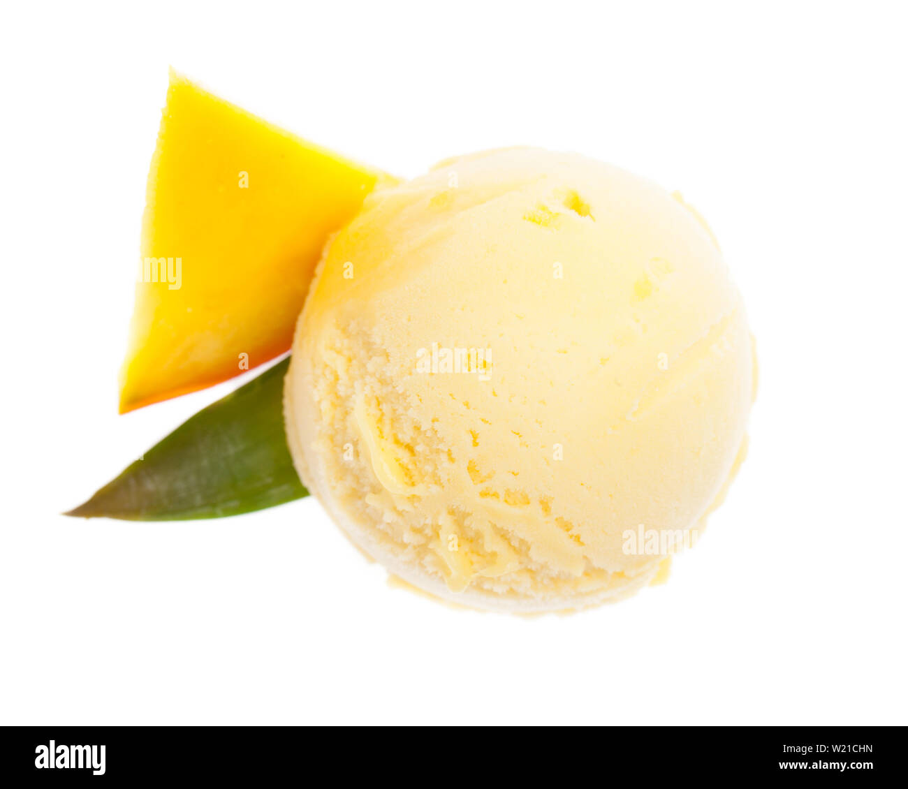 A scoop of mango ice cream from the top with fruit isolated on white ...