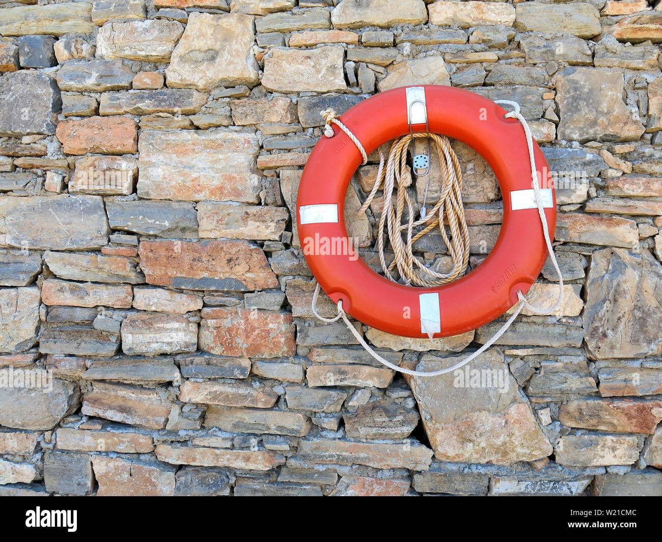 Life ring with line attached to it hanging on a wall at a holiday ...