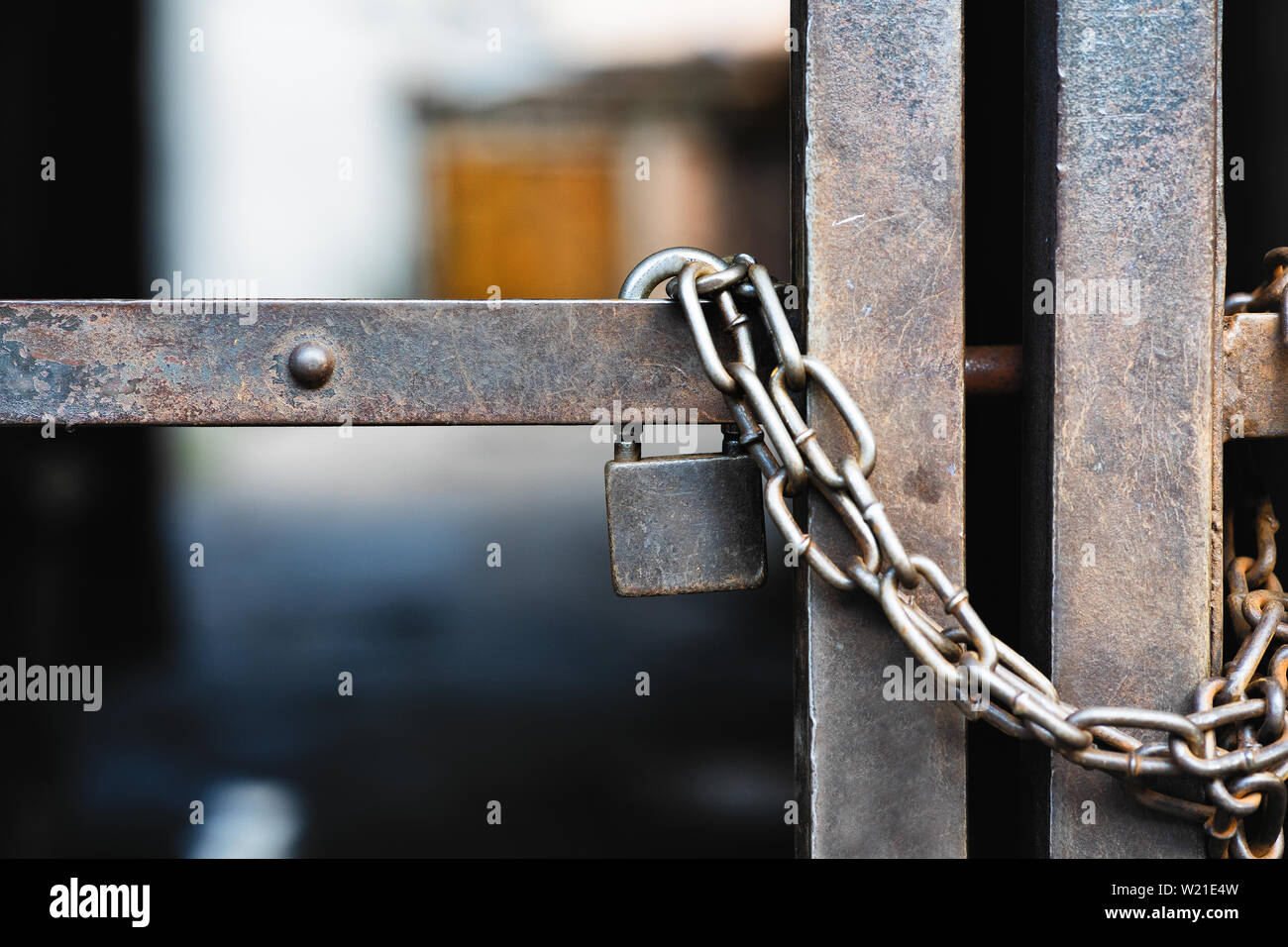 Metal padlock with a chain on a closed iron gate at the entrance Stock ...