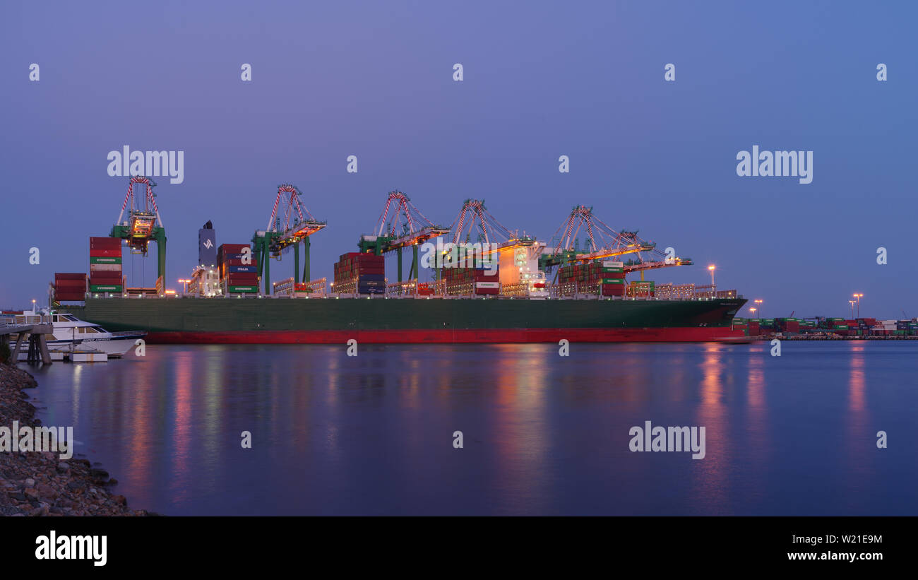Image, looking east, showing a docked container ship in the process of ...